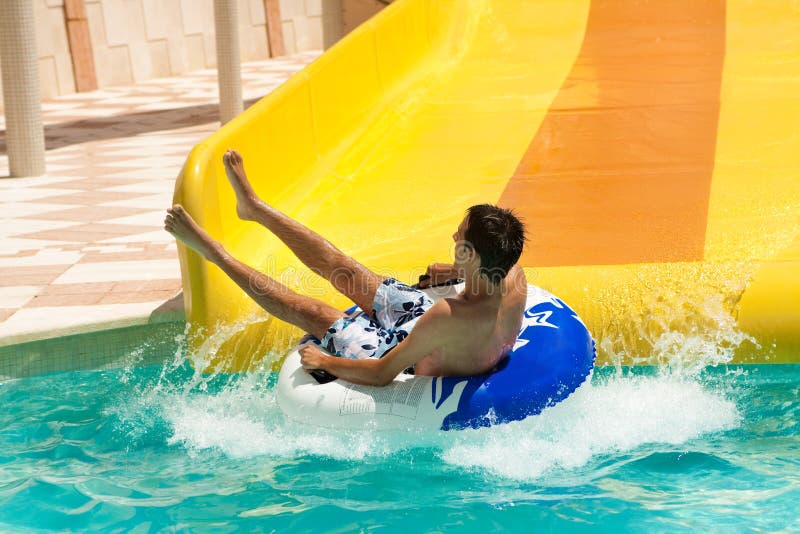 Aqua Park Fun - Man Enjoying a Water Tube Ride Stock Photo - Image of ...