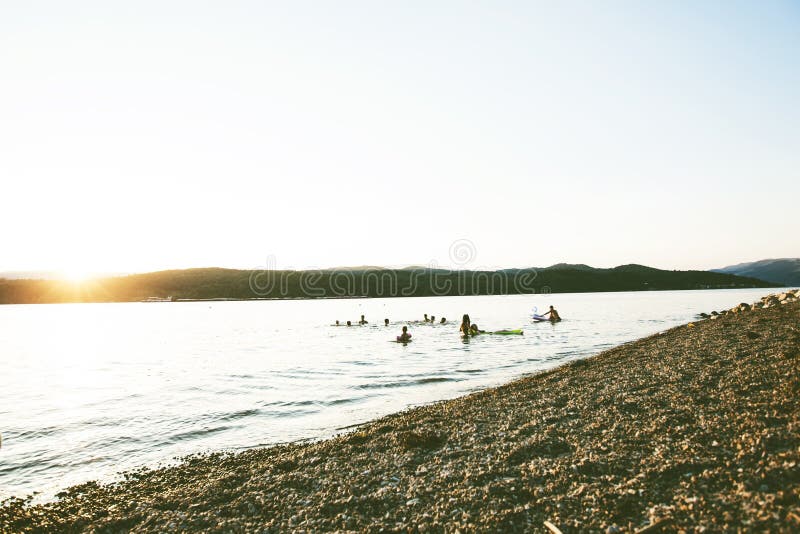 Summer Fun, Friends Enjoy Sunset on the Beach, Splashing in Water Stock ...
