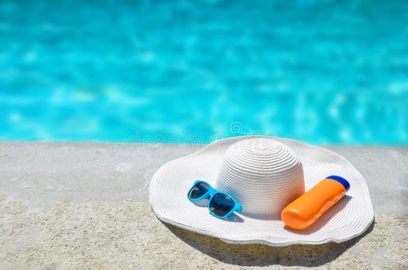Summer Hat, Sunglasses and Sunscreen Near the Pool Stock Image - Image ...