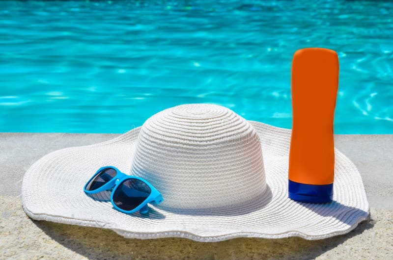Summer Hat, Sunglasses and Sunscreen Near the Pool Stock Photo - Image ...