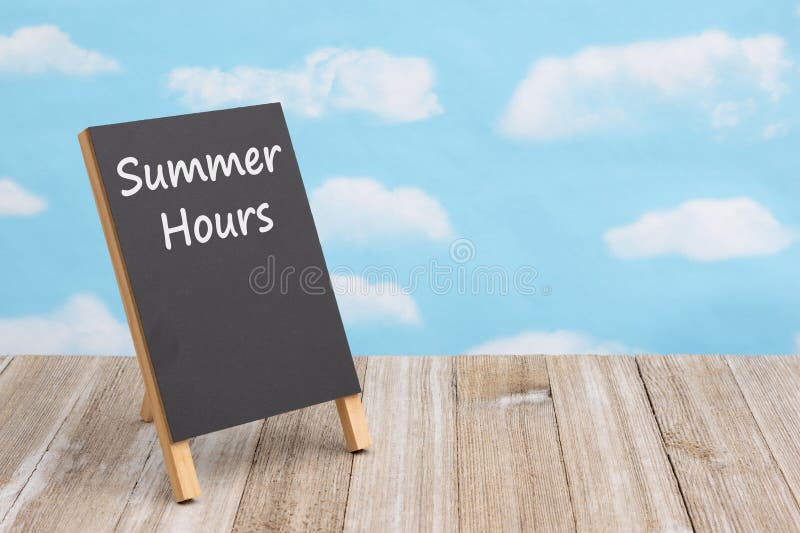Summer Hours on a Chalkboard Easel on a Table with Sky Stock Photo ...