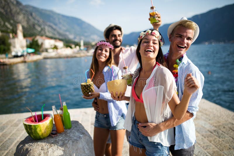 Group of Friends at Beach Drinking and Having Fun. Summer Party. Stock ...