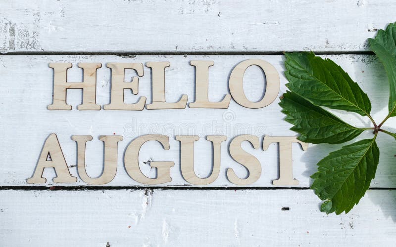 Summer Pattern: Word Hello, August and Green Leaves on a White Wooden ...