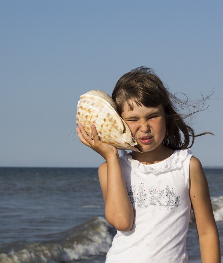 Summer Vacation - Beautiful Girl with Shell at the Beach Stock Photo ...