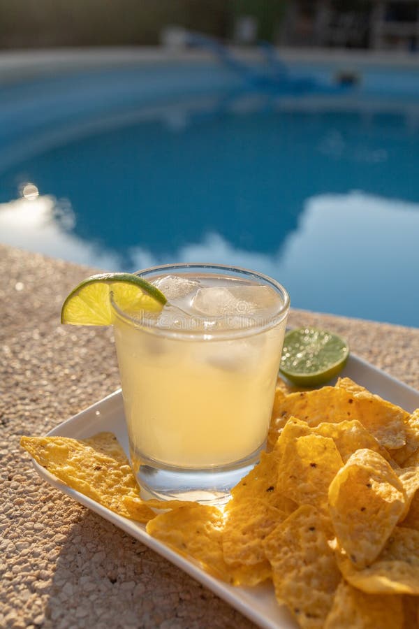 Summer Vibes with Kombucha and Nachos by the Pool Stock Image - Image ...