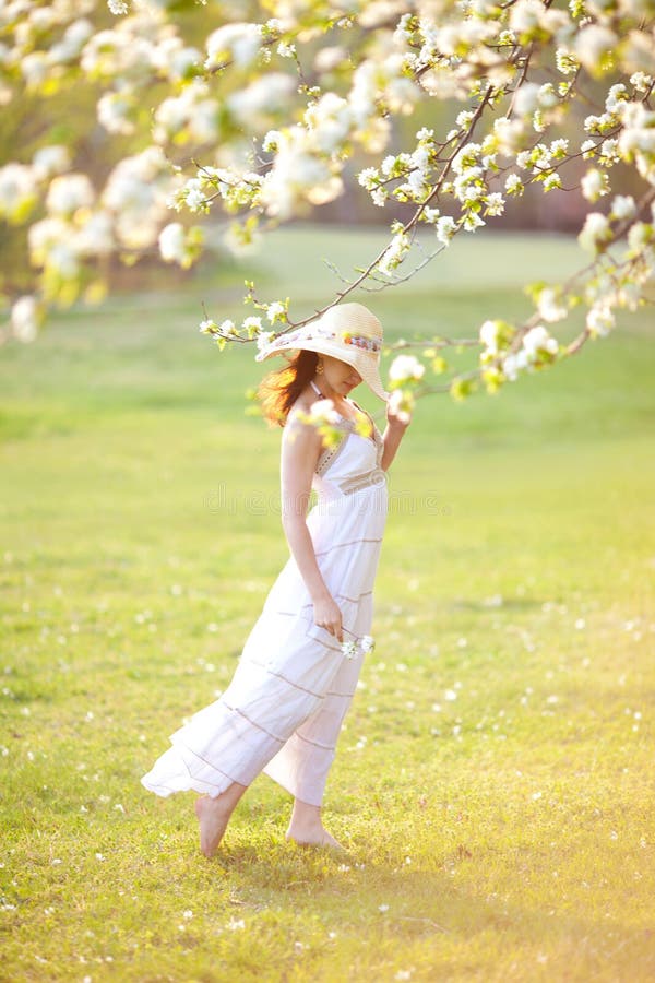 Woman Enjoying Spring in the Green Field with Blooming Trees Stock ...
