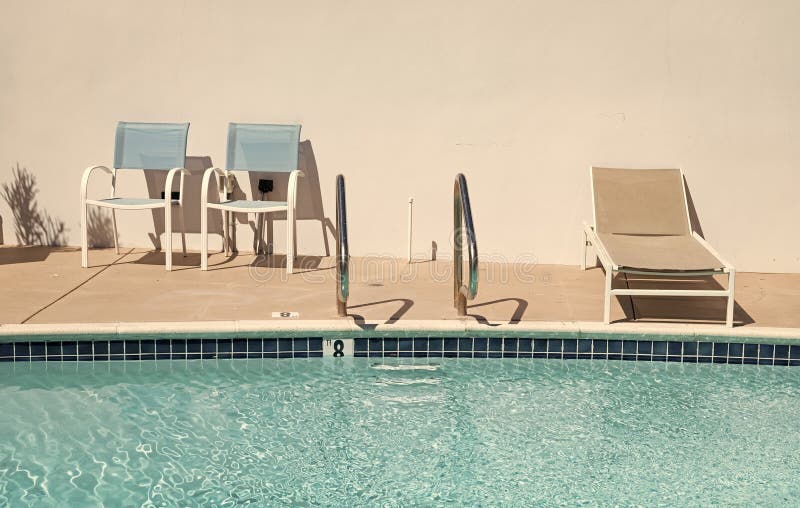 Summertime Poolside with Sunbed at Blue Pool Water Stock Image - Image ...
