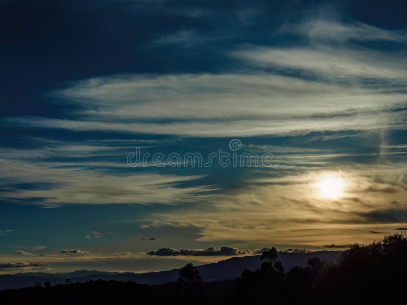 The Sun Barely Hidden Behind a Translucent Cloud in the Sunset Stock ...