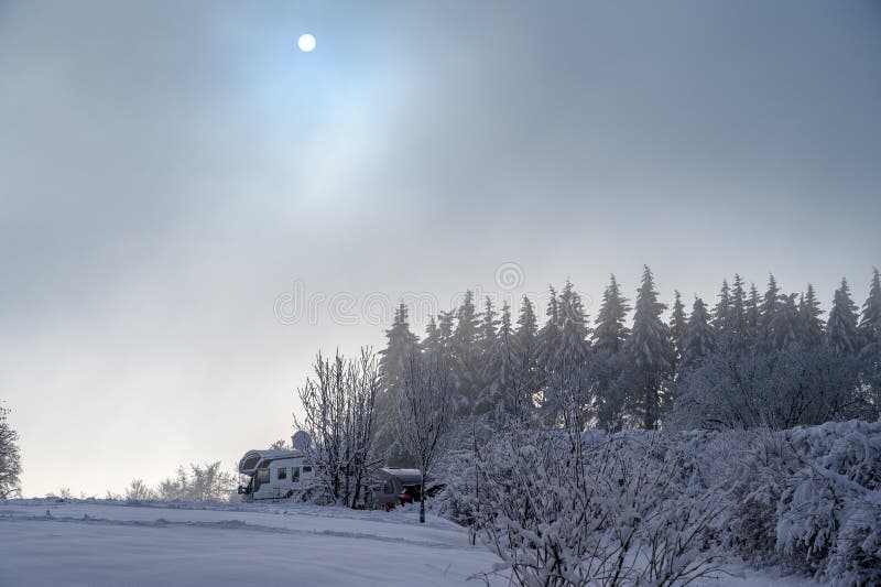 Sun Barely Visible through Clouds in Snow Landscape with a Mobile Home ...