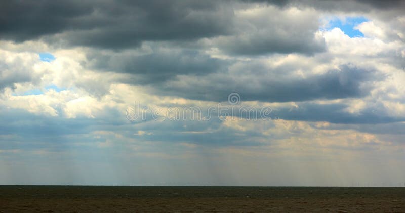 Sun Beam through Heavy Sky before a Powerful Storm , View from Seashore ...