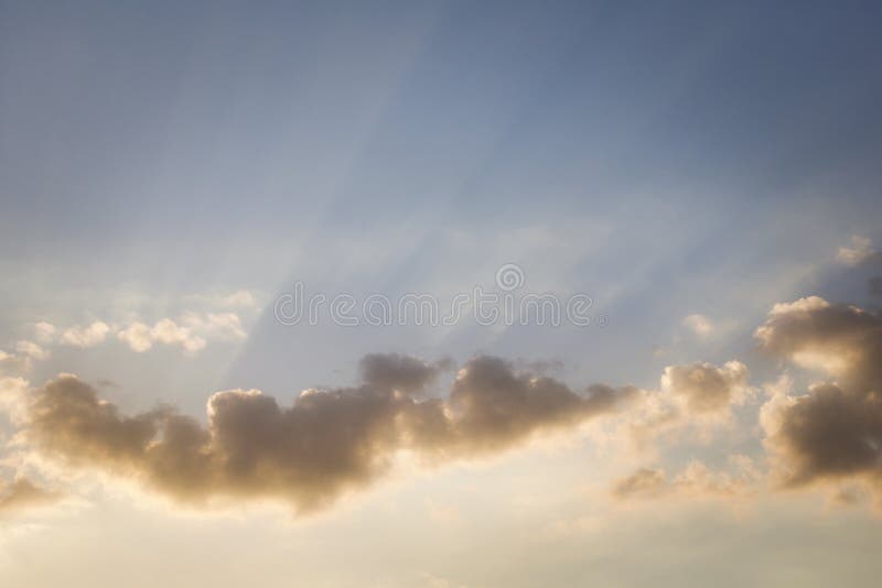 Sun Beams Over a Group of Clouds at Sunset Stock Image - Image of ...
