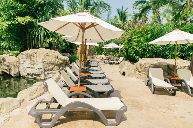 Sun Bed Beside Swimming Pool. Stock Image - Image of decking, exotic ...