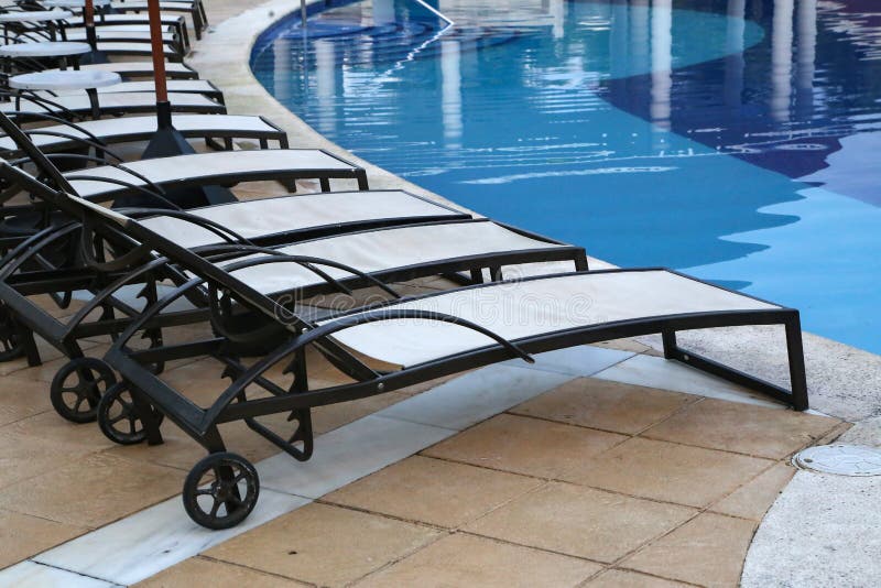 Sun Beds at the Edge of the Pool Stock Photo - Image of edge, landscape ...