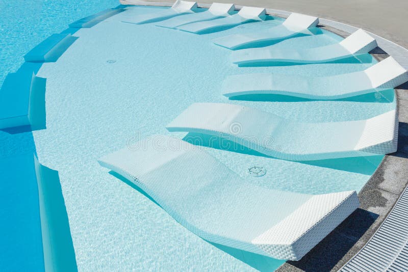 Sun Beds. Sun Beds in the Water. Swimming Pool Stock Photo - Image of ...