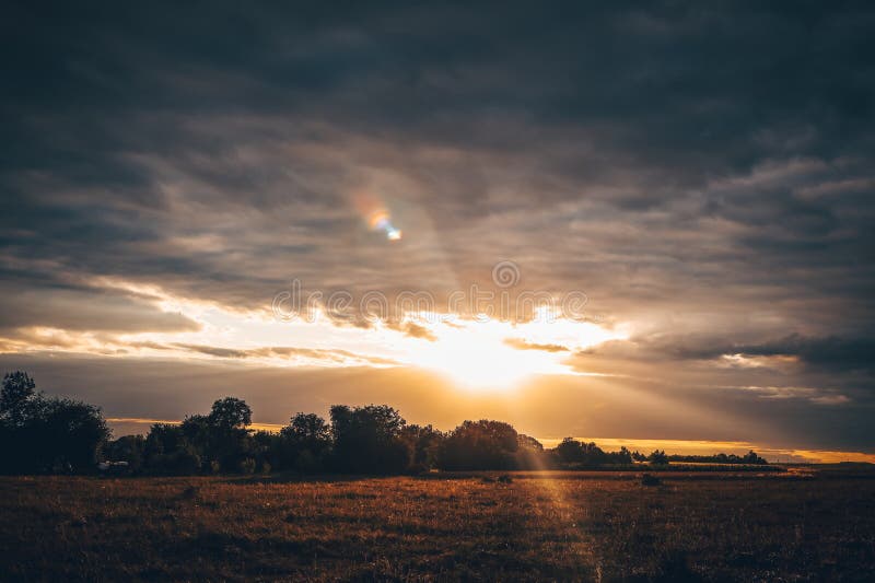 The Sun Behind the Cloud. Rays of Light from the Sun Stock Image ...