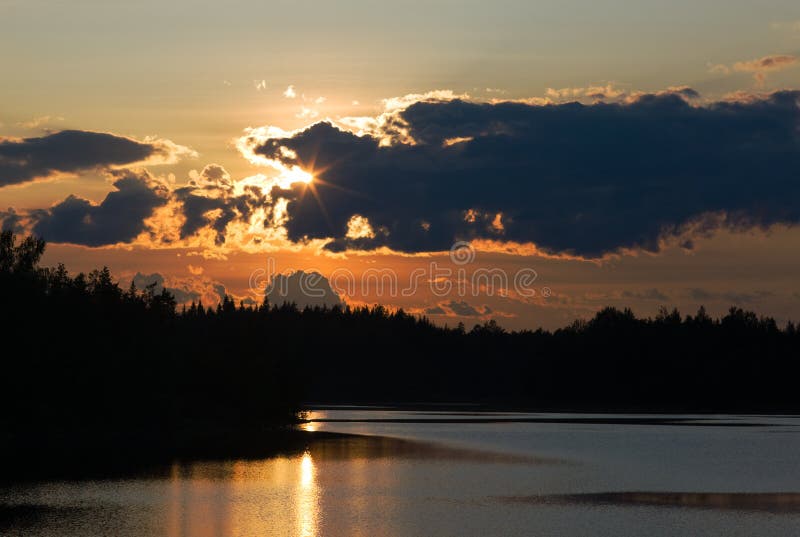 The sun behind clouds stock photo. Image of dusk, water - 10486892