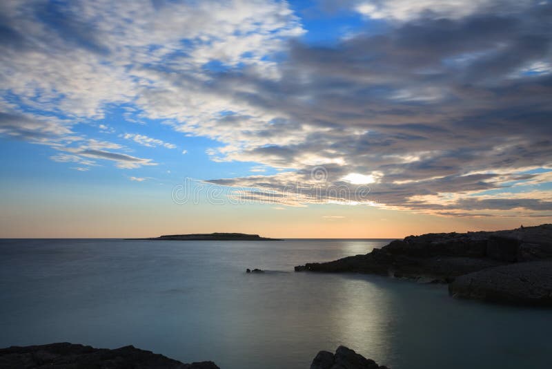 Sun Behind Clouds Above Sea Level in Sunset Time Stock Photo - Image of ...