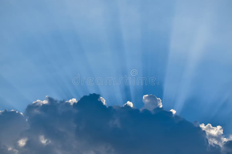 Sun Behind the Clouds with Sun Rays Streaks in the Cloudy Blue Sky with ...
