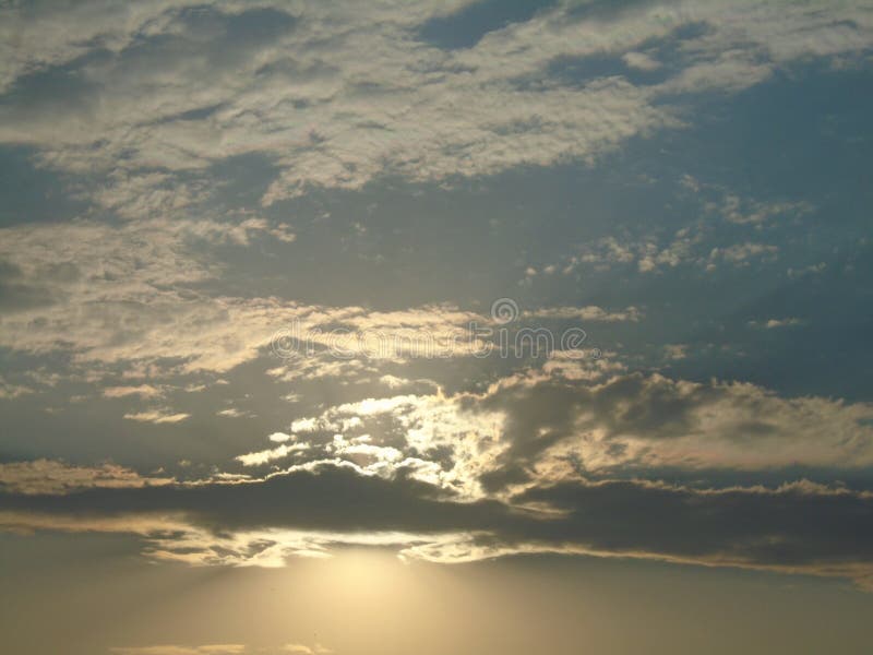 The sun behind the clouds stock image. Image of earth - 131138865