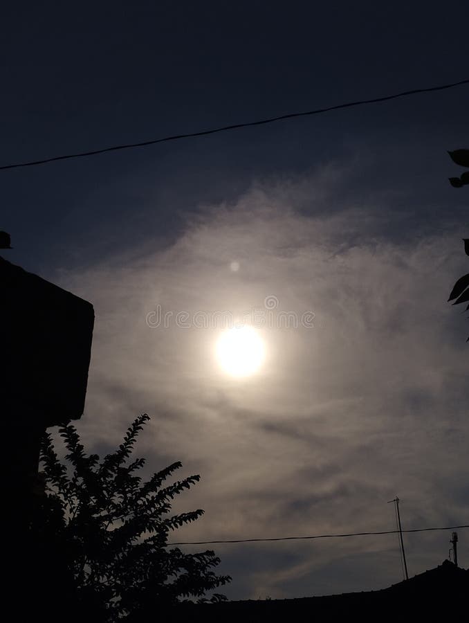 Sun Behind Cloudy Sky and Urban Silhouettes Stock Image - Image of ...