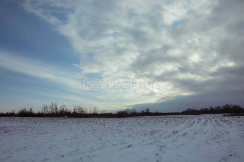 Sun Behind Gray Cloud and Snow-covered Field Stock Photo - Image of ...