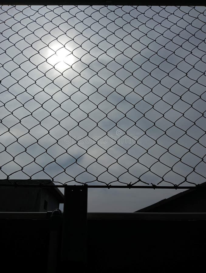 The Sun Behind the Mesh Wall Stock Photo - Image of warming, mesh ...