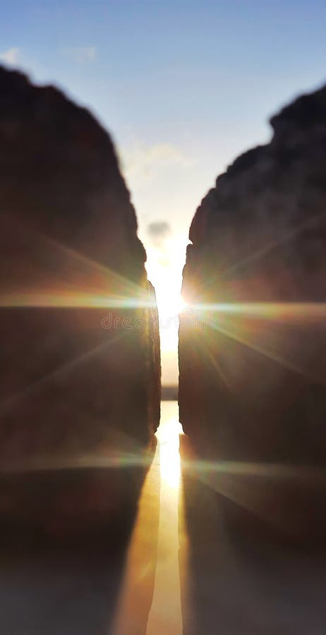 Sun behind the rocks stock image. Image of sunlight - 256227225