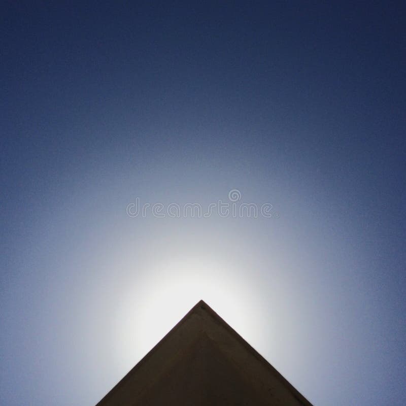 Sun behind triangle stock photo. Image of silhouette - 53707860