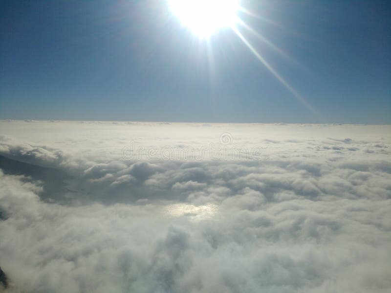 The Sun Blazing Down on the Top of a Layer of Clouds that Cover the ...