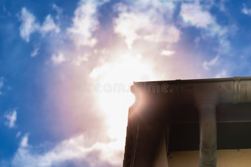 Sun and Blue Sky Behind a Roof Edge Seen from Below Stock Image - Image ...