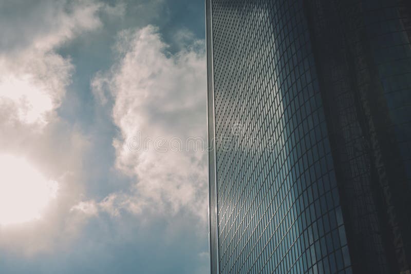 Flat Side of a Glass Sky Scraper with Sun and Clouds Stock Image ...
