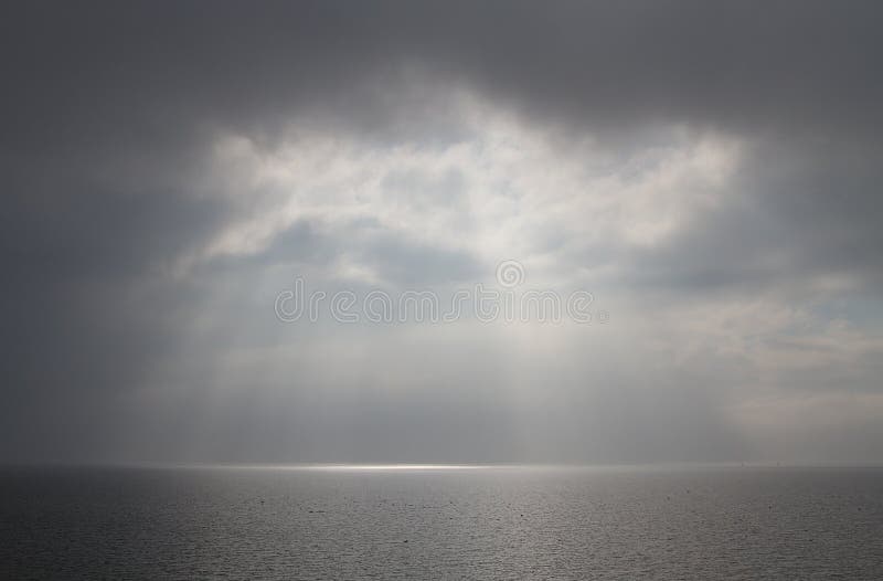 Sun Breaks through Above Misty Sea Stock Photo - Image of breaks ...