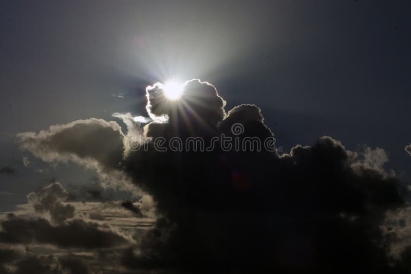 Bright Sun Shining through Dramatic Dark Storm Cloudscape with Silver ...