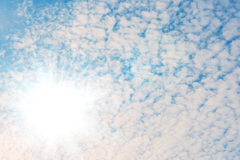 The Sun with Bright Rays in the Blue Sky with White Light Clouds Stock ...