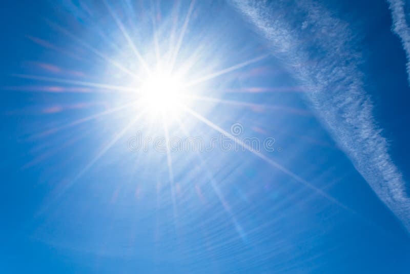 The Sun with Bright Rays in the Blue Sky with White Light Clouds Stock ...