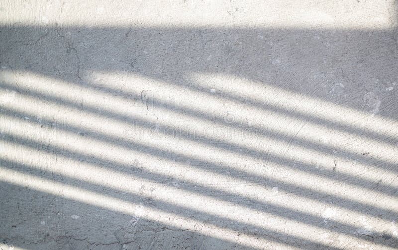 The Sun is Casting Railing Shadow Over the White Concrete Wall and ...