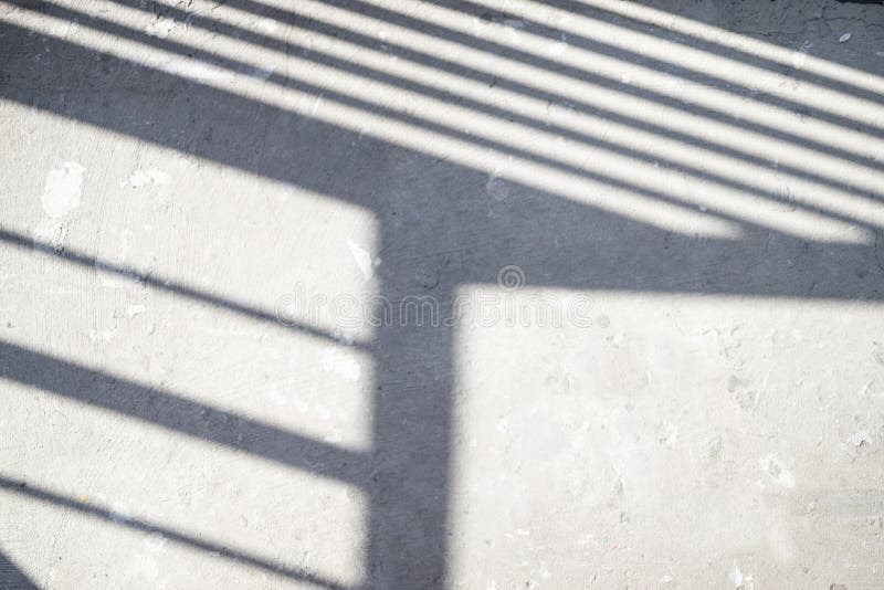 The Sun is Casting Railing Shadow Over the White Concrete Wall and ...