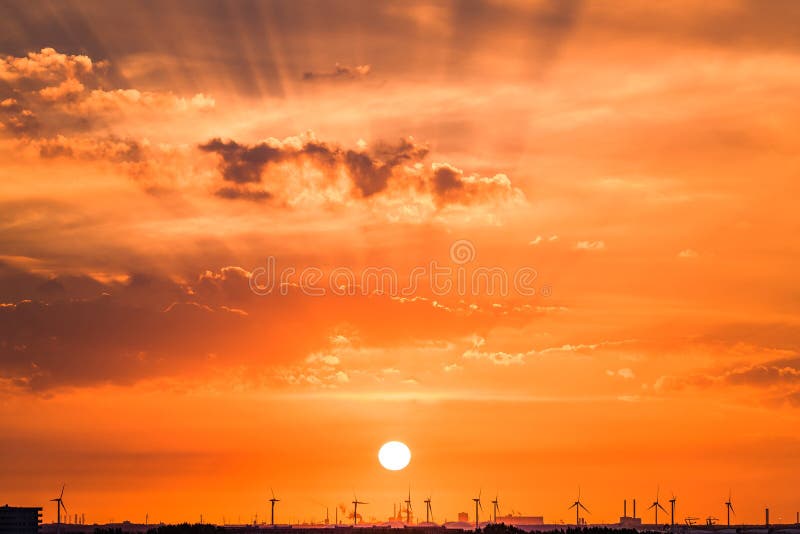 Sun Casting Rays through a Dramatic Orange Sky at Sunset Stock Photo ...