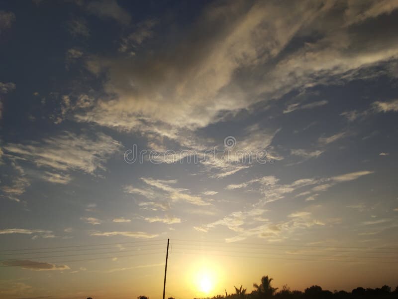Sun with Clouds and Trees stock image. Image of dawn - 188048565
