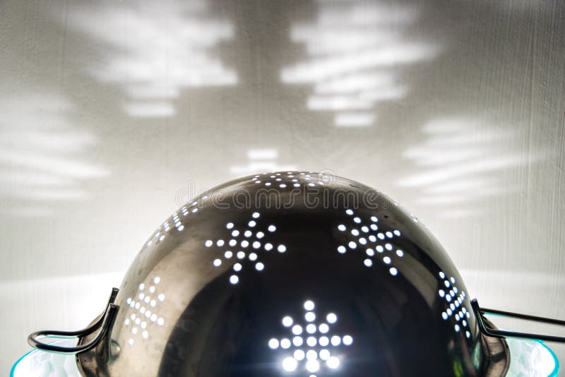 The Sun in a Colander. Rays of Light through the Holes Stock Photo ...