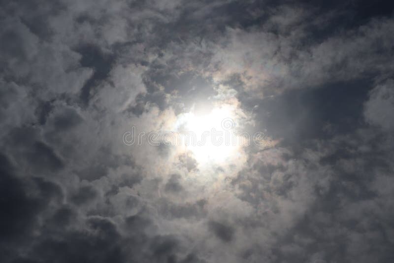 Sun coming out of clouds stock photo. Image of clouds - 180059690