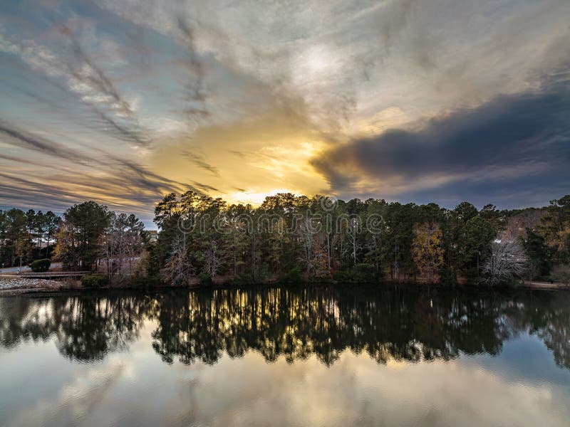 The Sun is Coming Out on a Sunset Lake in the Country Stock Photo ...