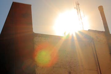 Sun Coming Up Over Brick Building Stock Photo - Image of outdoors ...