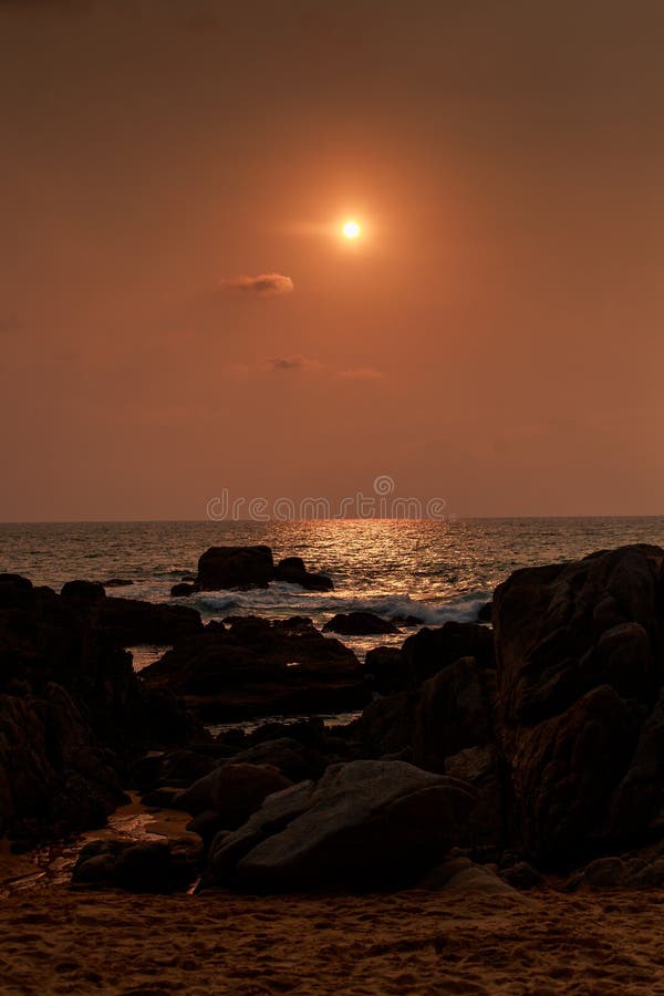 Sun Disk Over Sea at Sunrise Dark Rocks on Foreground Stock Photo ...