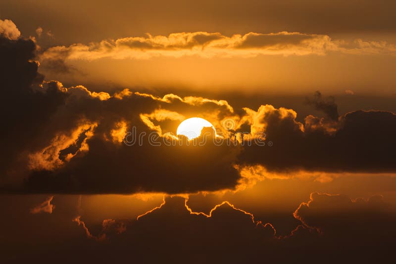 Sun Disk Peeks Out from Behind Dramatic Backlit Clouds Stock ...