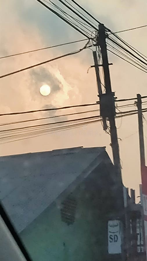 The Sun at Dusk, the Colors of Dusk Circled by Black Clouds Stock Photo ...