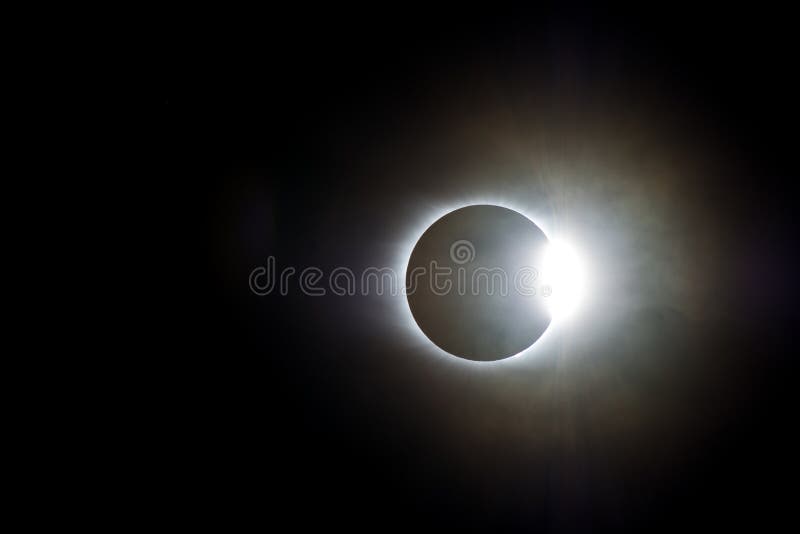 The Sun Emerges from Behind the Moon on a Cloudy Day Stock Image ...
