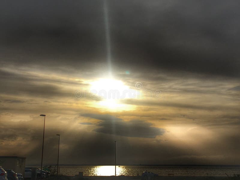 Sun in evening clouds stock image. Image of sunset, evening - 99874401