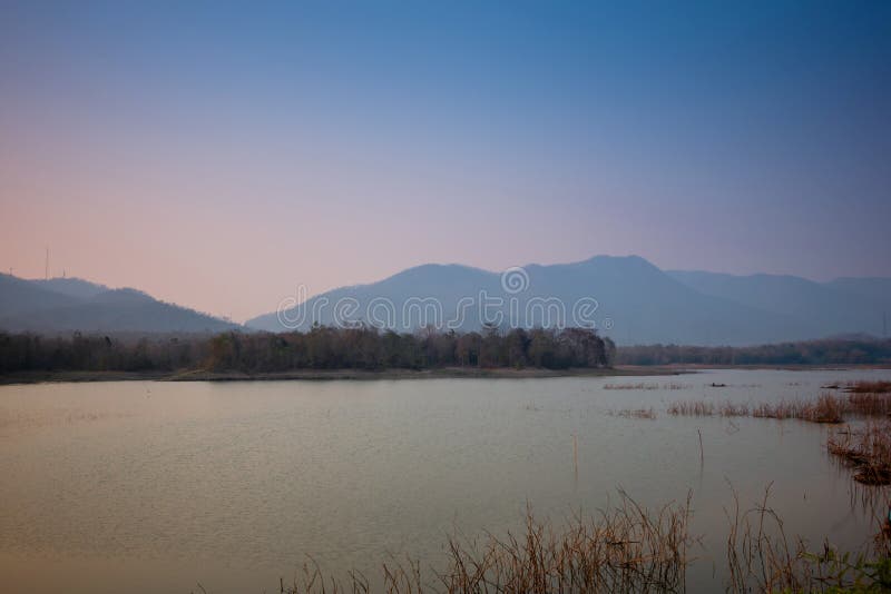The Sun is Falling with Mountain View Stock Image - Image of water ...