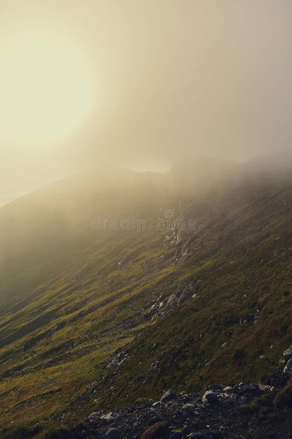 The Sun Filtered through the Clouds and the Fog in the Mountains Stock ...